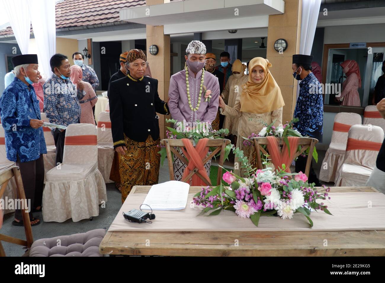 A traditional groom with his parents before the wedding ceremony begin ...
