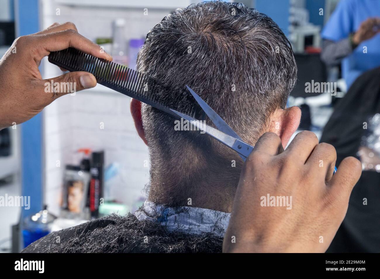 Close up shot of man getting haircut at barber shop Stock Photo - Alamy