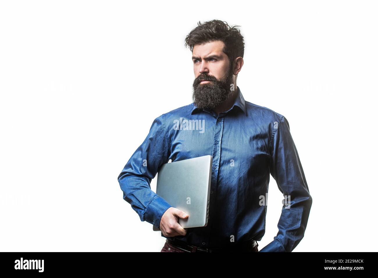 Holding laptop computer. Serious handsome bearded man worker laptop ...