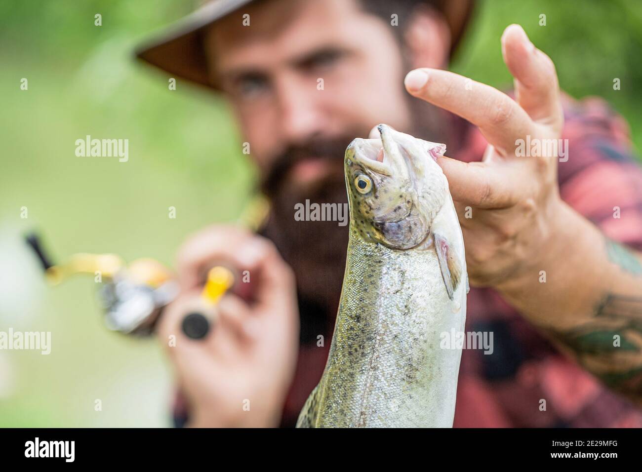 Fishing. Angler with fishing trophy. Fisherman and trout. Fishing ...