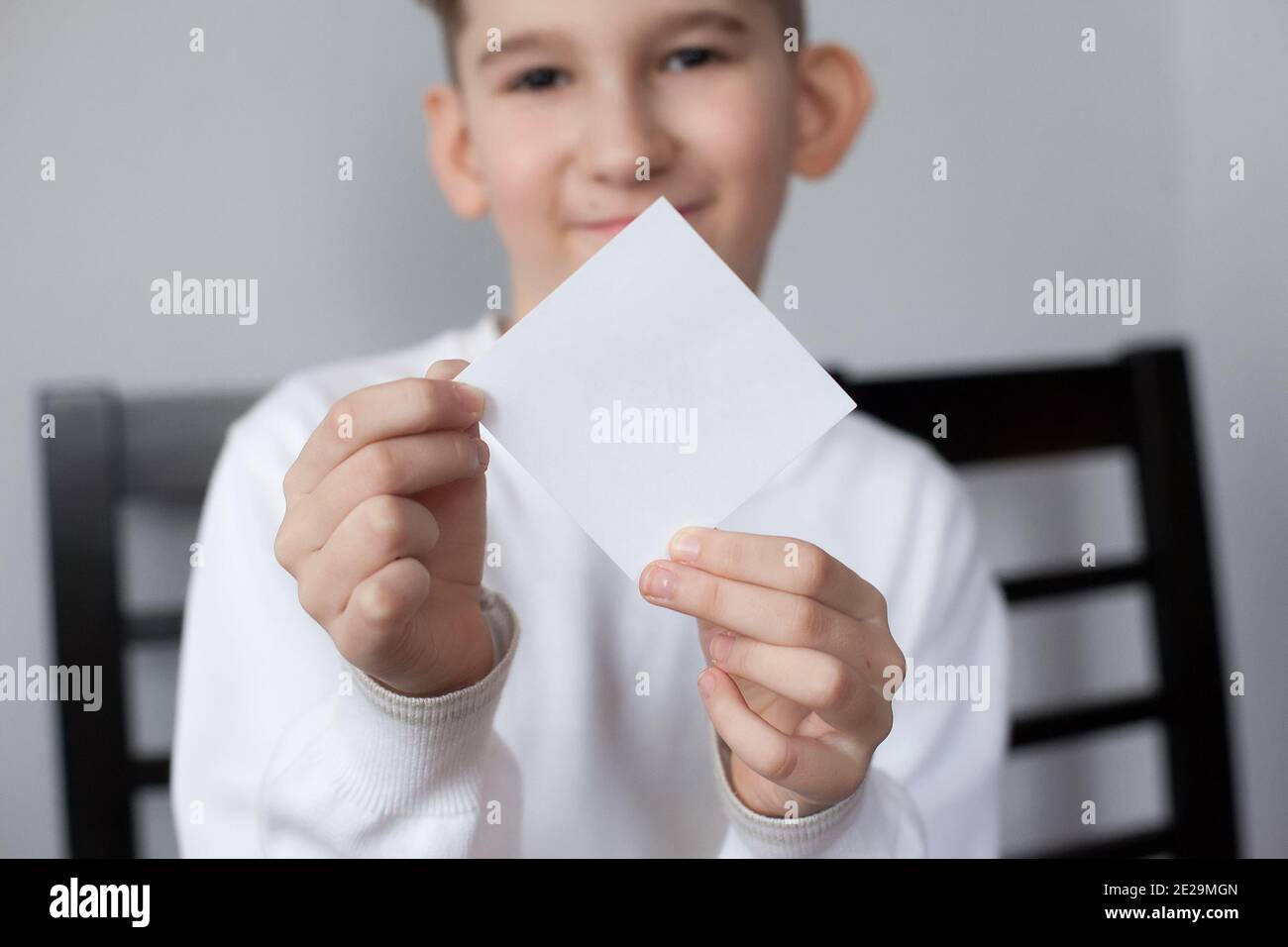 Funny blurred boy holding sheet of white paper for your text Stock ...