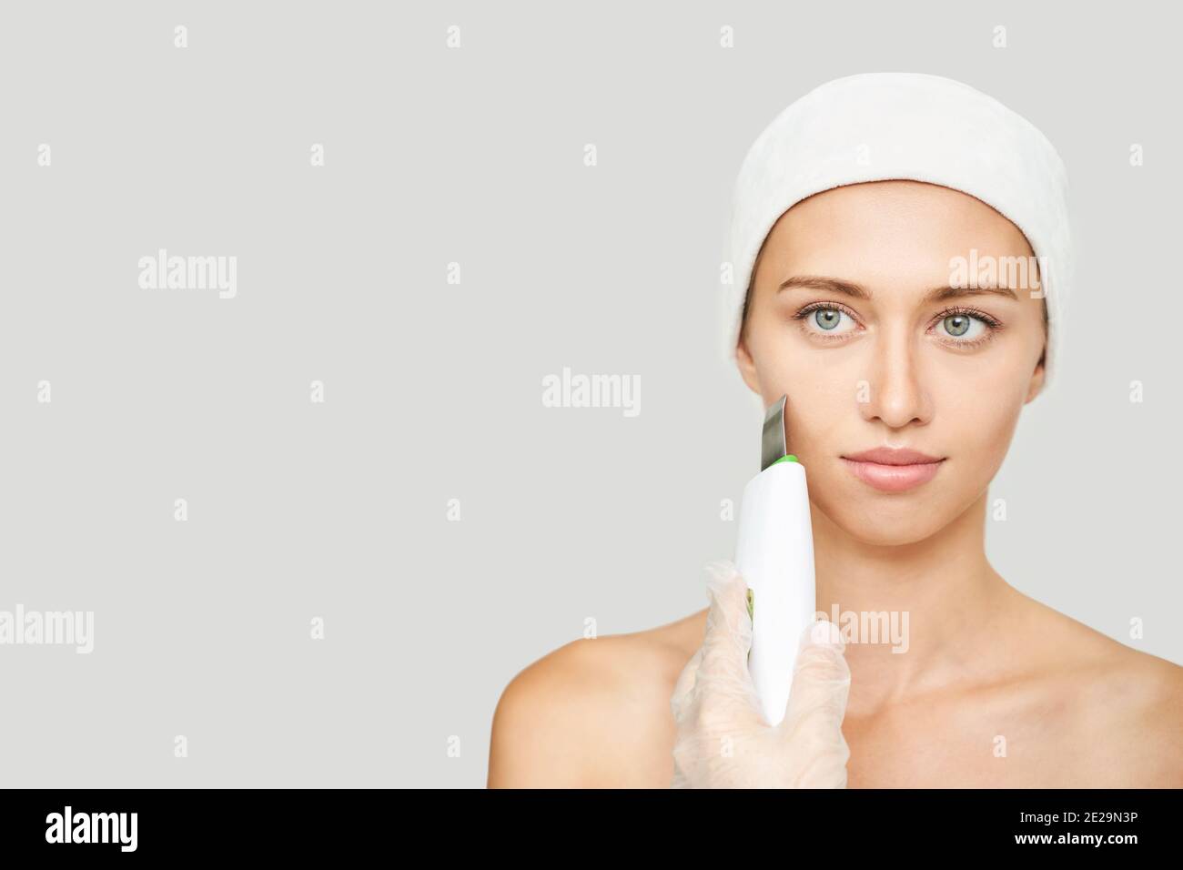 Ultrasonic skin equipment. Woman face cosmetology treatment. Female ...