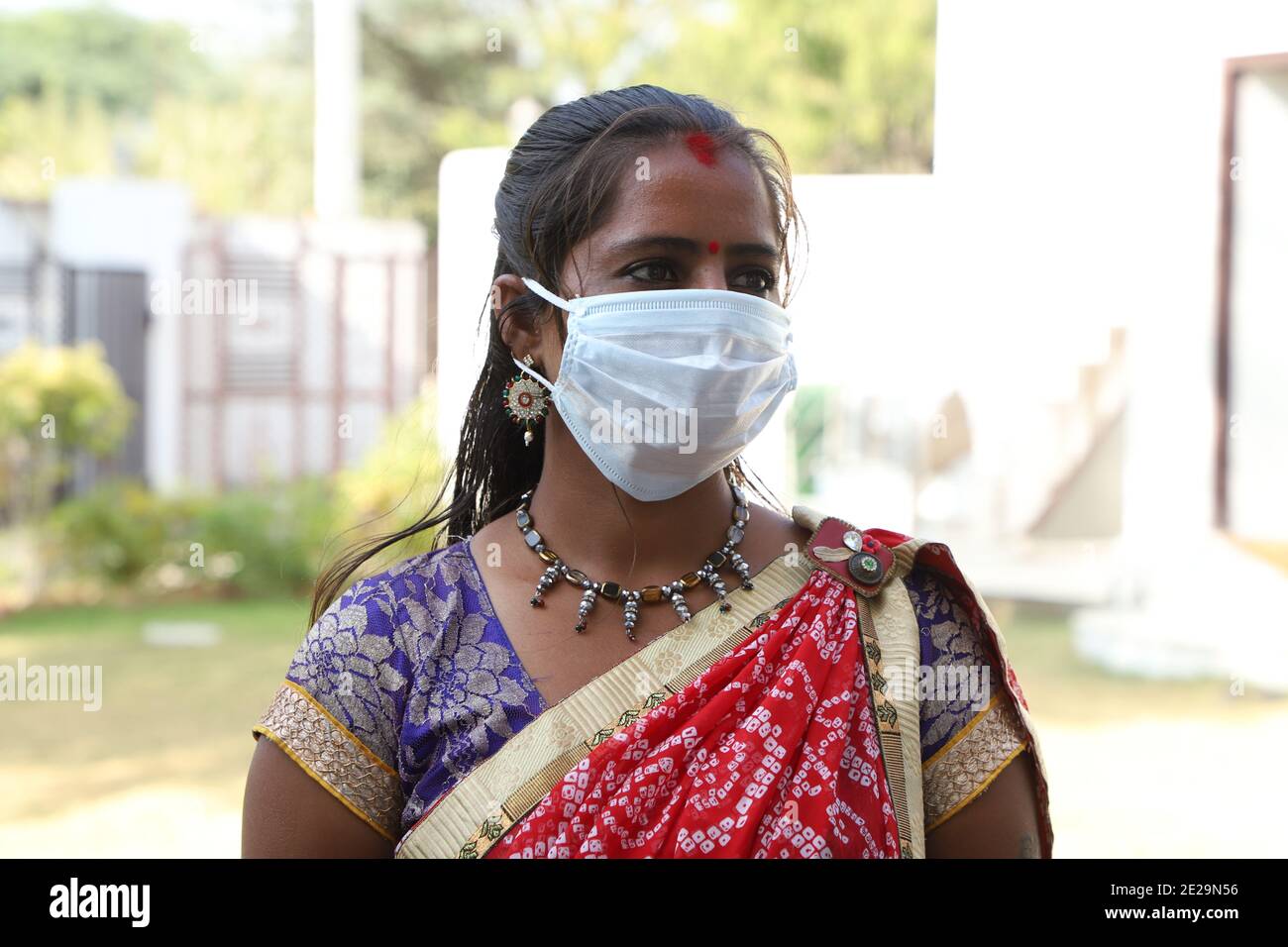 Closeup shot of a young Indian female wearing a mask standing outdoors Stock Photo - Alamy