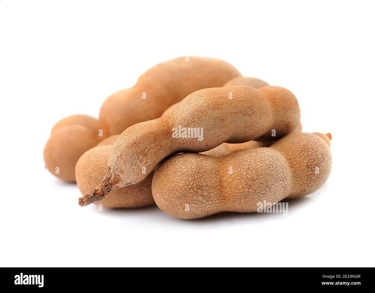 Fresh tamarind pods close up on white backgrounds.Tamarindus fruits ...