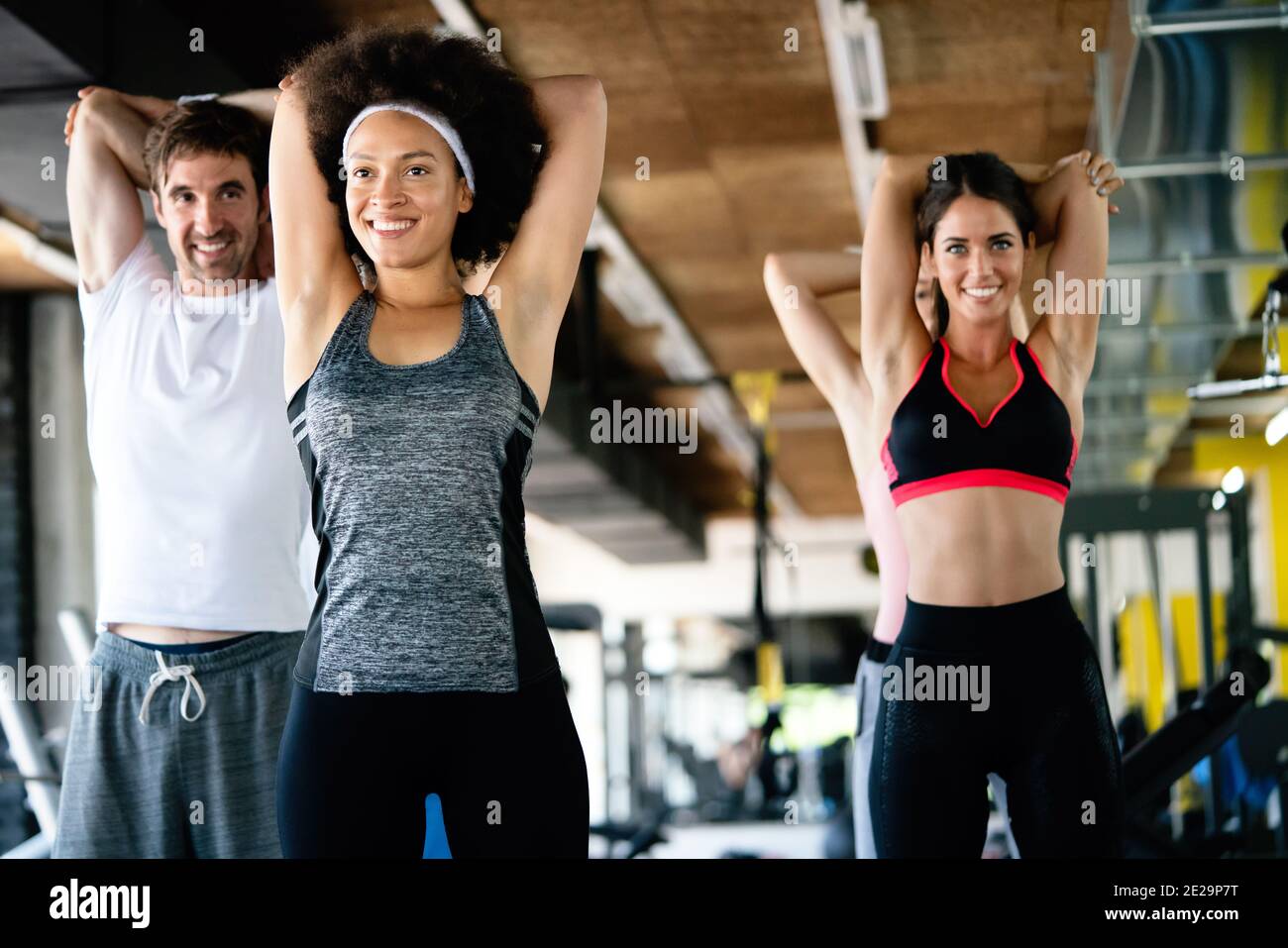 Group of happy multiracial friends exercising together in gym Stock ...