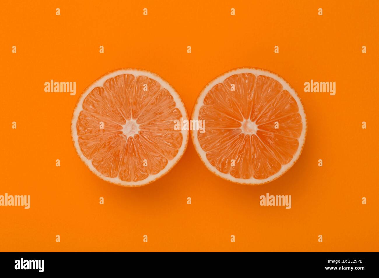 Lemon slices on orange minimal background. Bright juicy lemon on orange ...