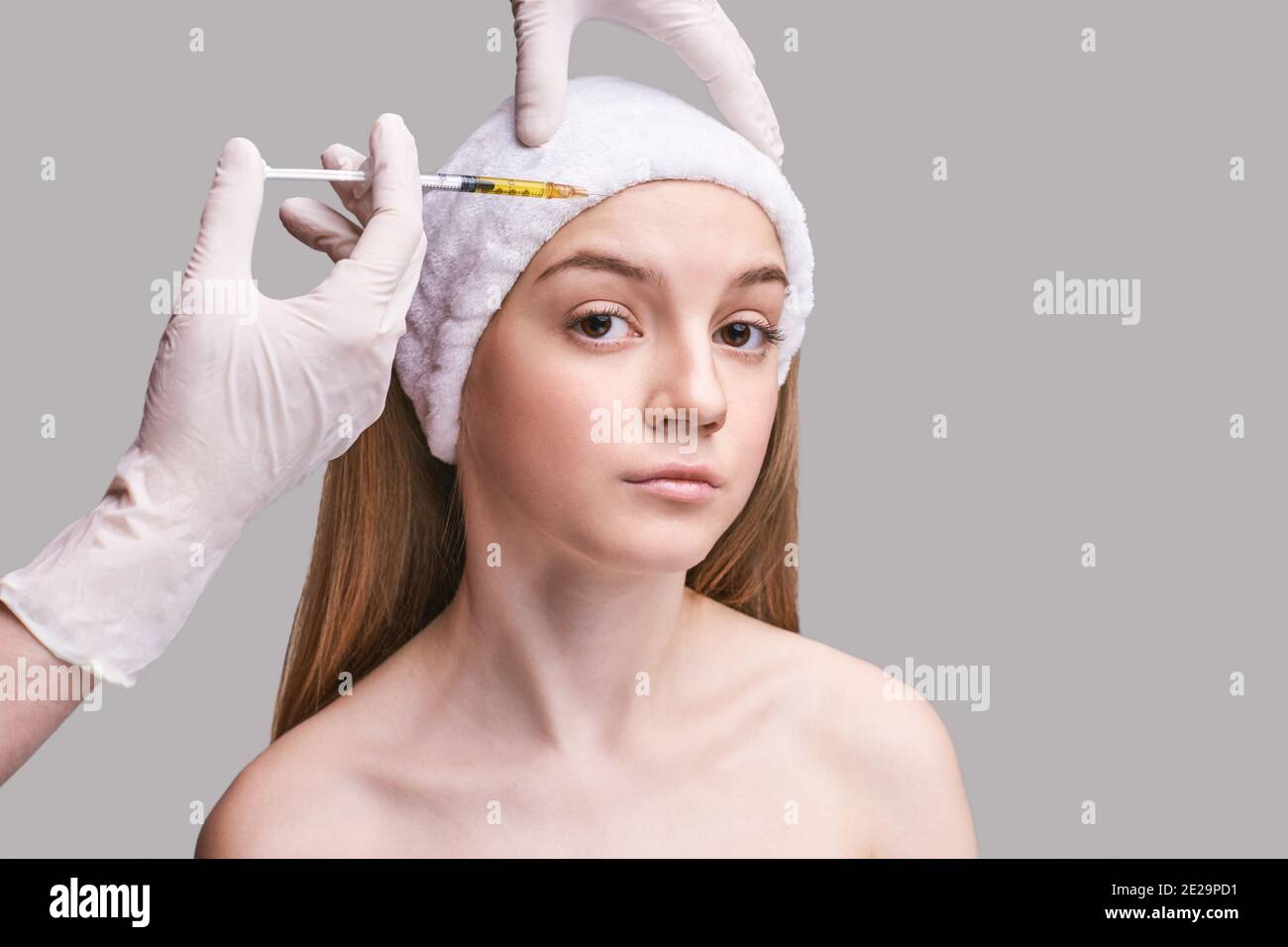 Forehead injection at spa salon. Doctor hands. Pretty female patient ...