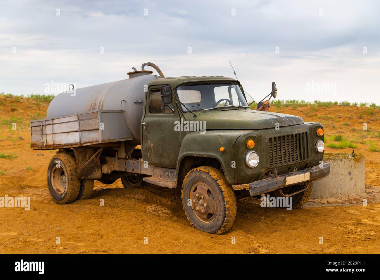 Truck with water tank in sand desert Stock Photo - Alamy