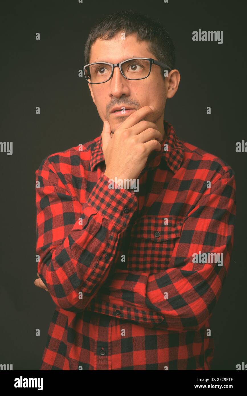 Hispanic man against black background Stock Photo - Alamy