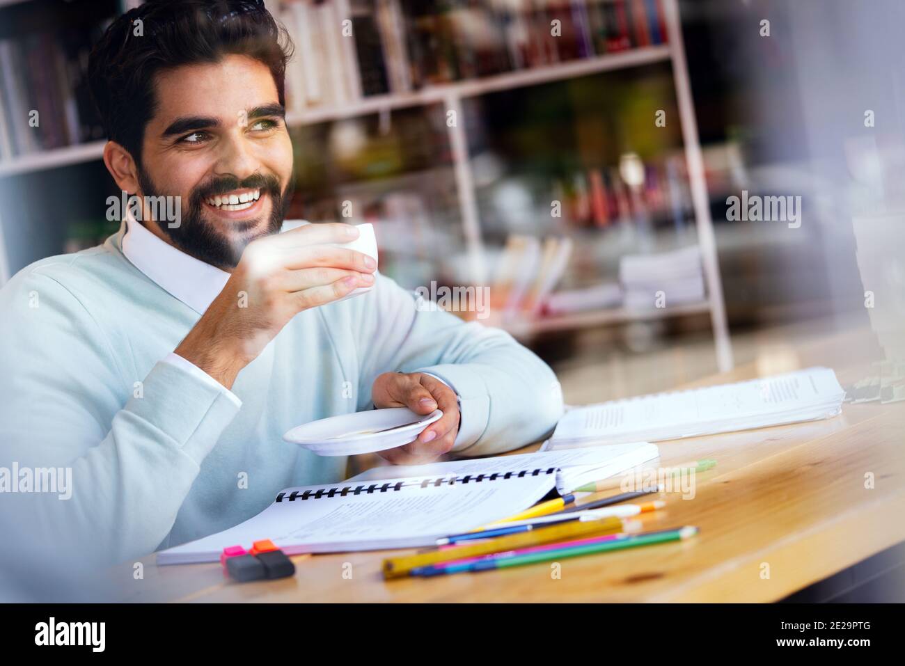 Portrait of young guy drinking coffee while studying in cafe Stock ...