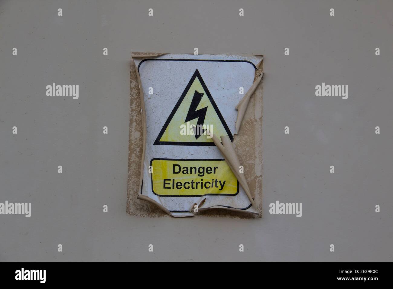 Electric danger symbol with a words DANGER ELECTRICITY. Sticker is old ...