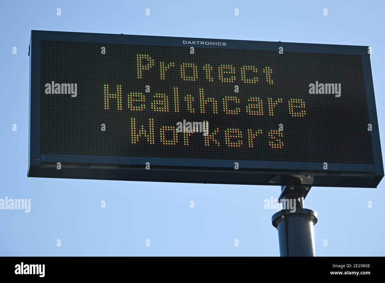 A message board is illuminated reading “Protect Healthcare Workers ...