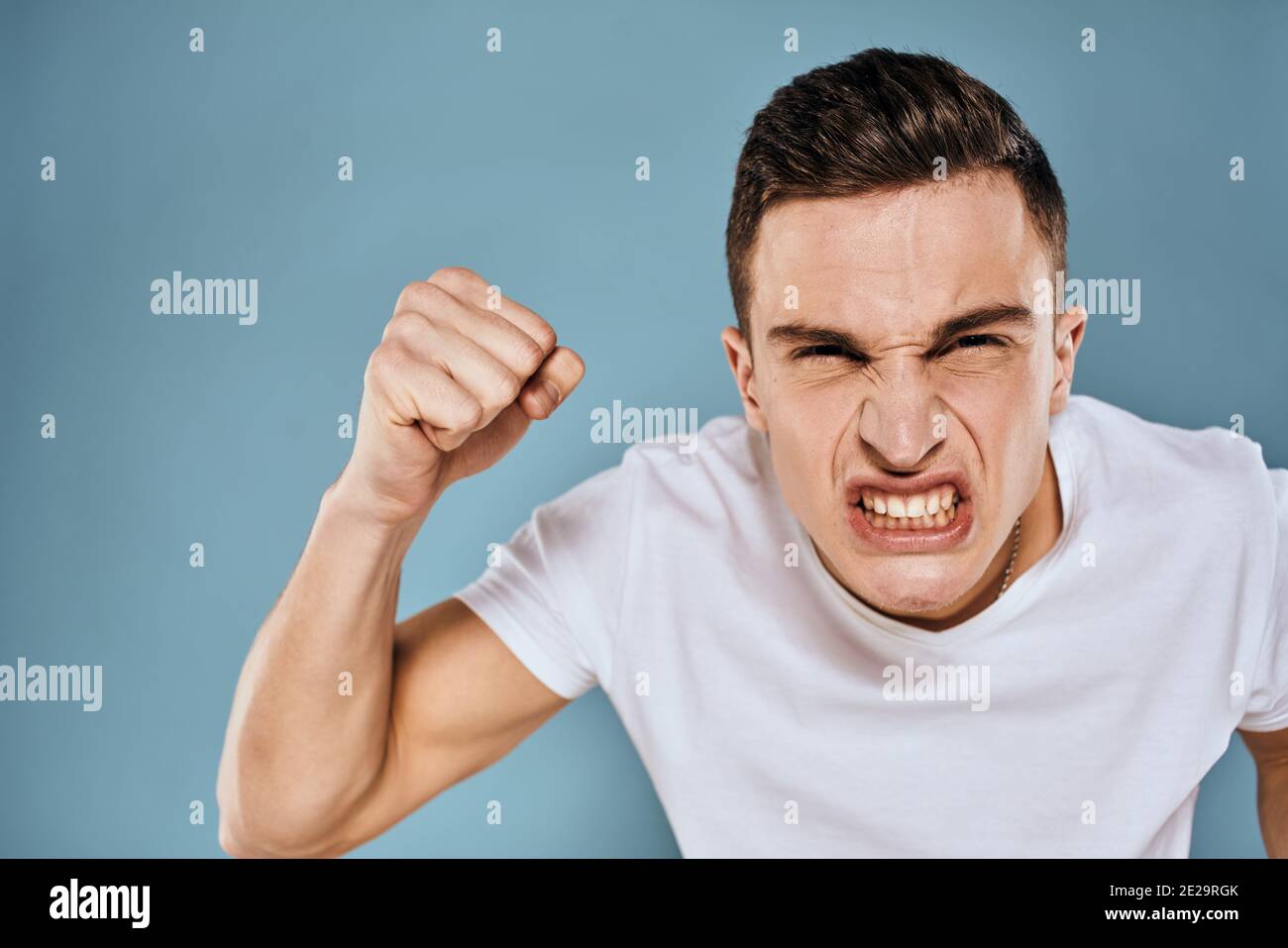 Man gestures with his hands emotions white t-shirt expression blue ...