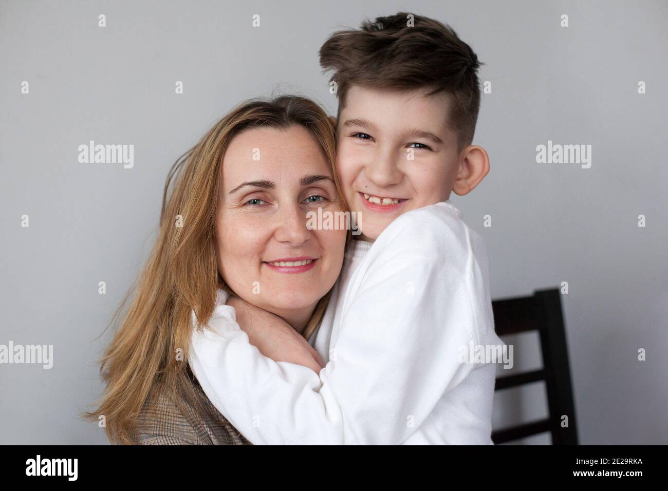 Happy mother hugging her son at home Stock Photo - Alamy