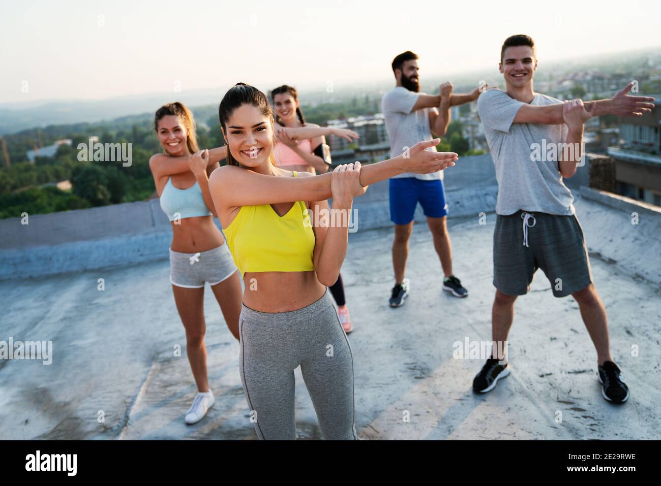 Group of fit healthy friends, people exercising together outdoor Stock ...