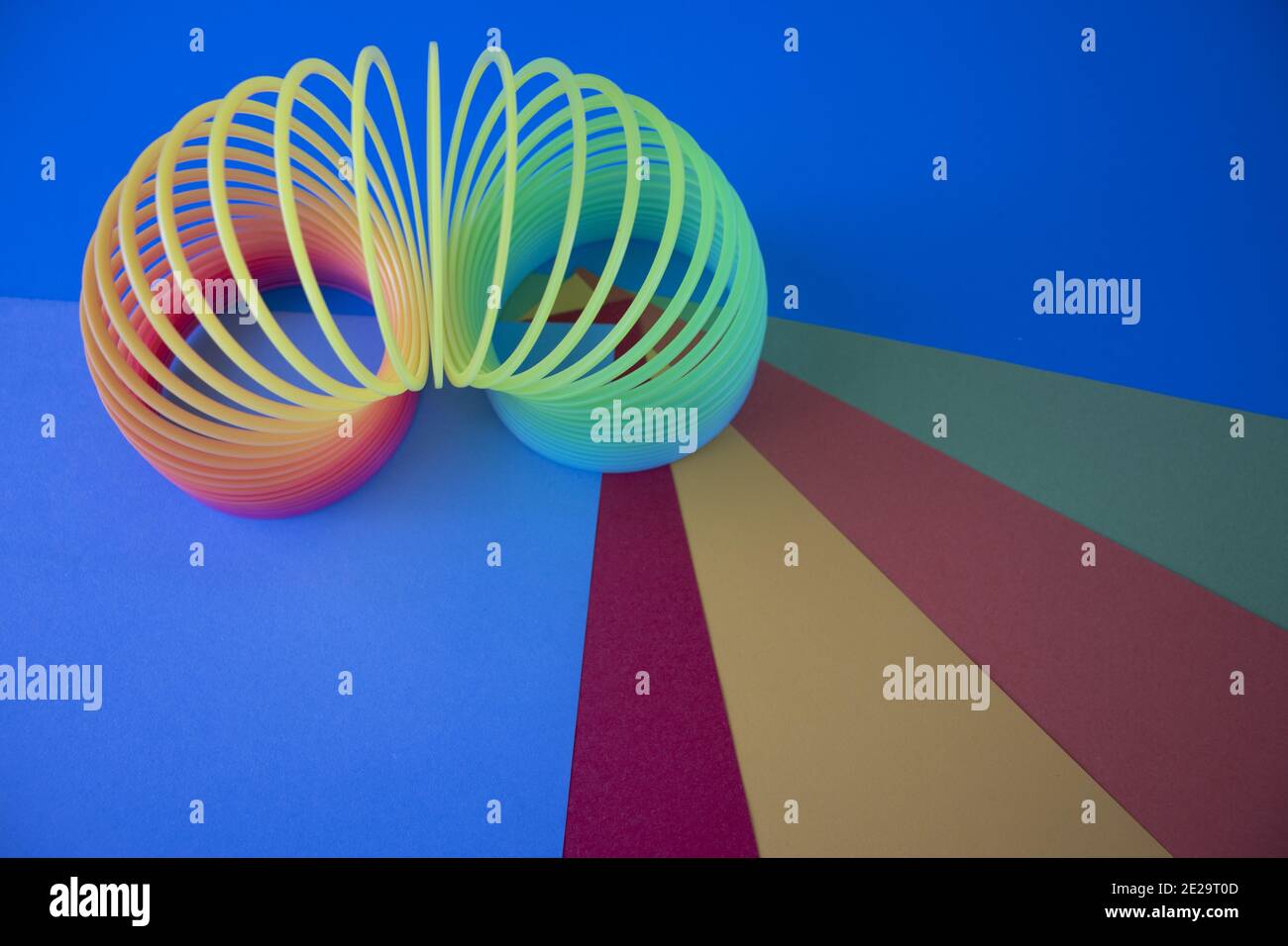 Top view of plastic rainbow magic spring toy against colorful ...
