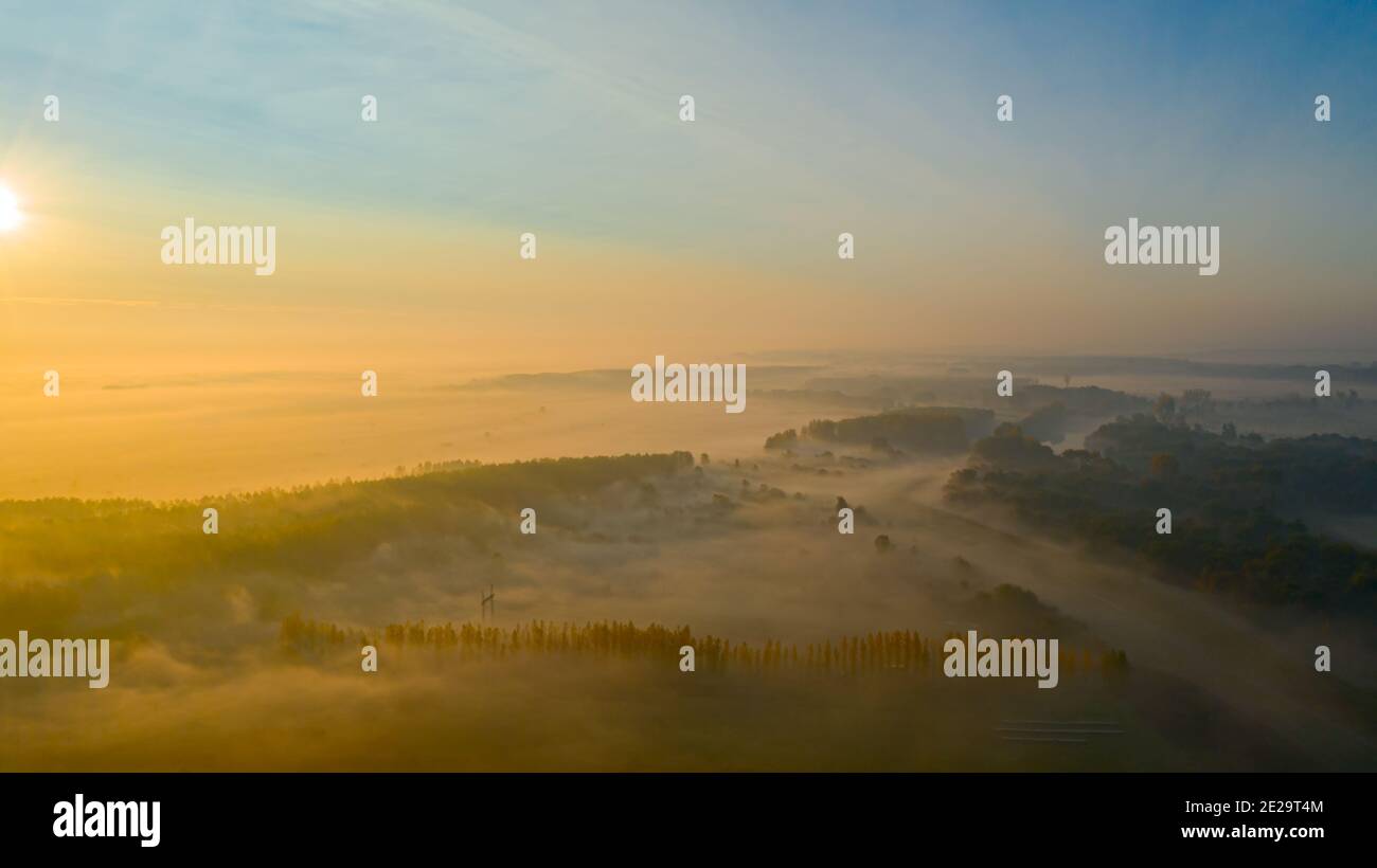 Aerial view of early morning mist, slowly floating vapor, steam in ...
