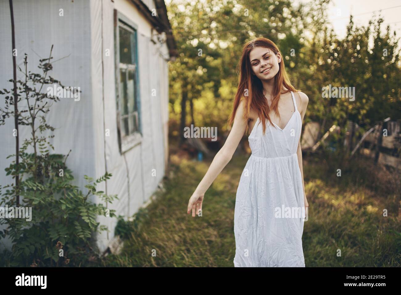woman outdoors near building on vacation model countryside landscape ...