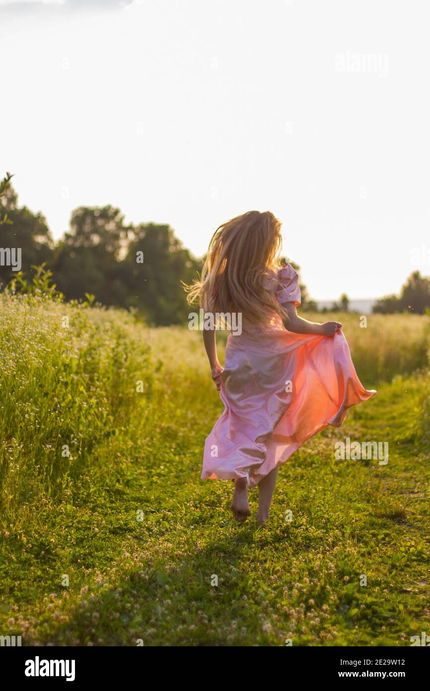 Woman running in field of flowers hi-res stock photography and images ...