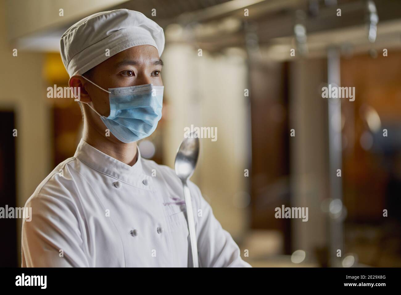 Copy space close-up photo of proud Asian male chef in his toque and ...
