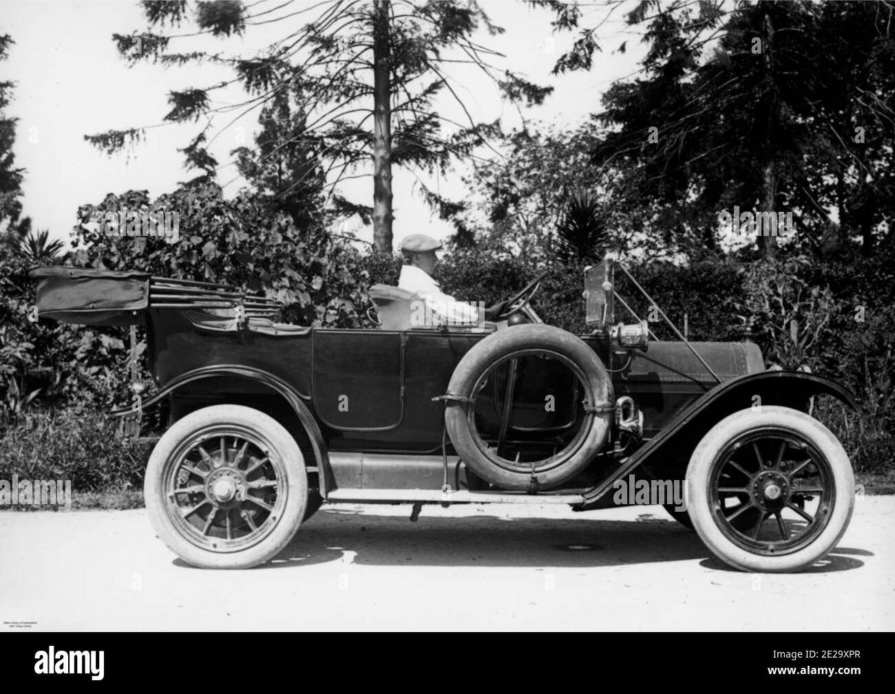 Antique vintage black and white photograph of a man driving a 1912 ...