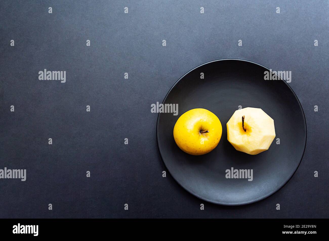 Yellow apple and apple without a peel on a dark background. Healthy ...