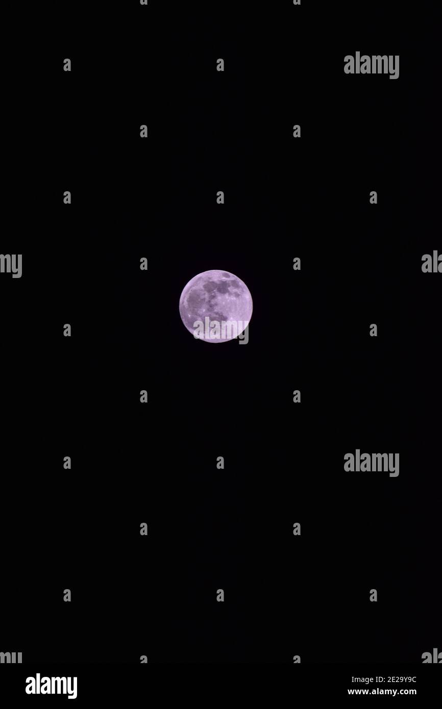 Vertical shot of full moon isolated on black background - perfect for ...