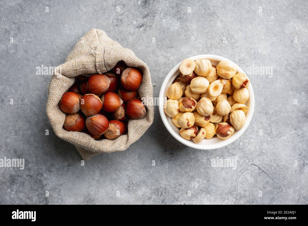 Hazelnuts peeled and in shell on gray background. Background and ...