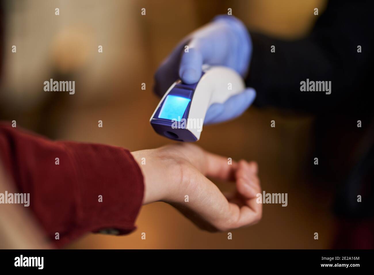 Cropped photo of service worker using contactless thermometer to check ...