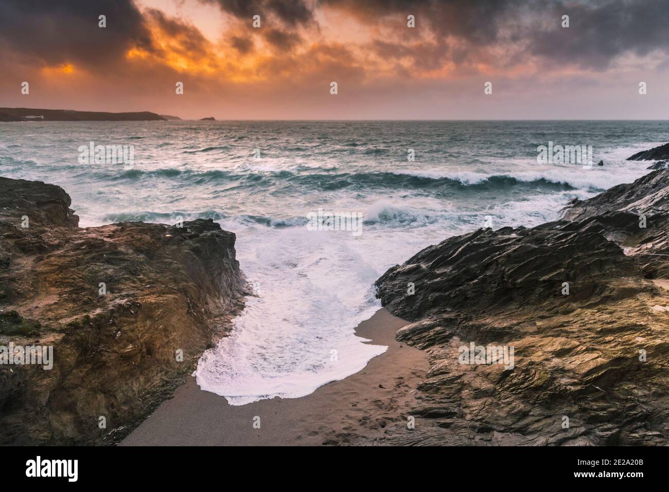 A dramatic sunset over incoming tide at Little Fistral in Newquay in ...