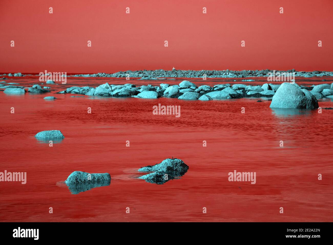 Fantasy seascape. Red sky and calm shallow sea water with boulders ...