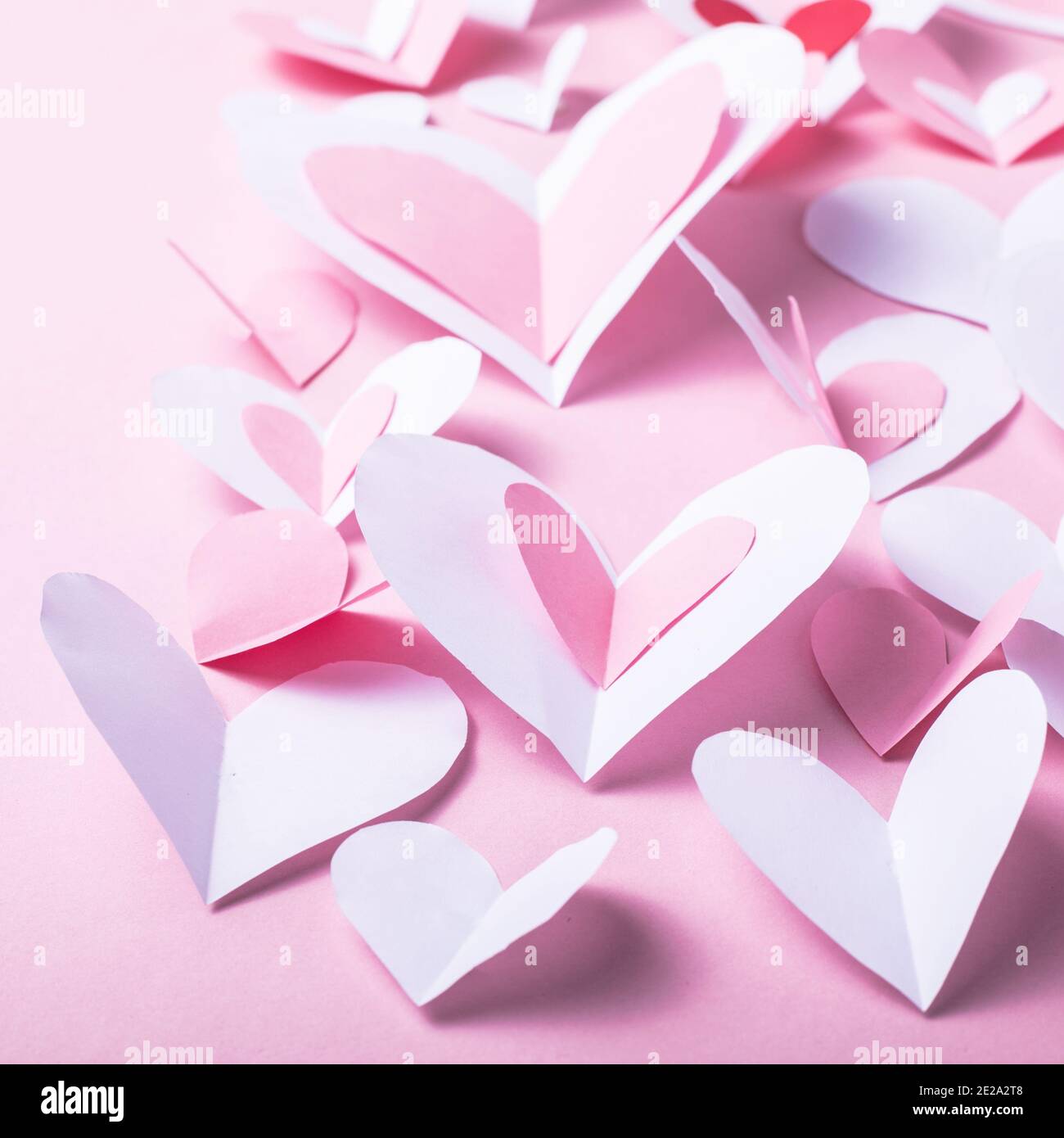 Valentine's Day festive background with pink and white paper hearts on ...