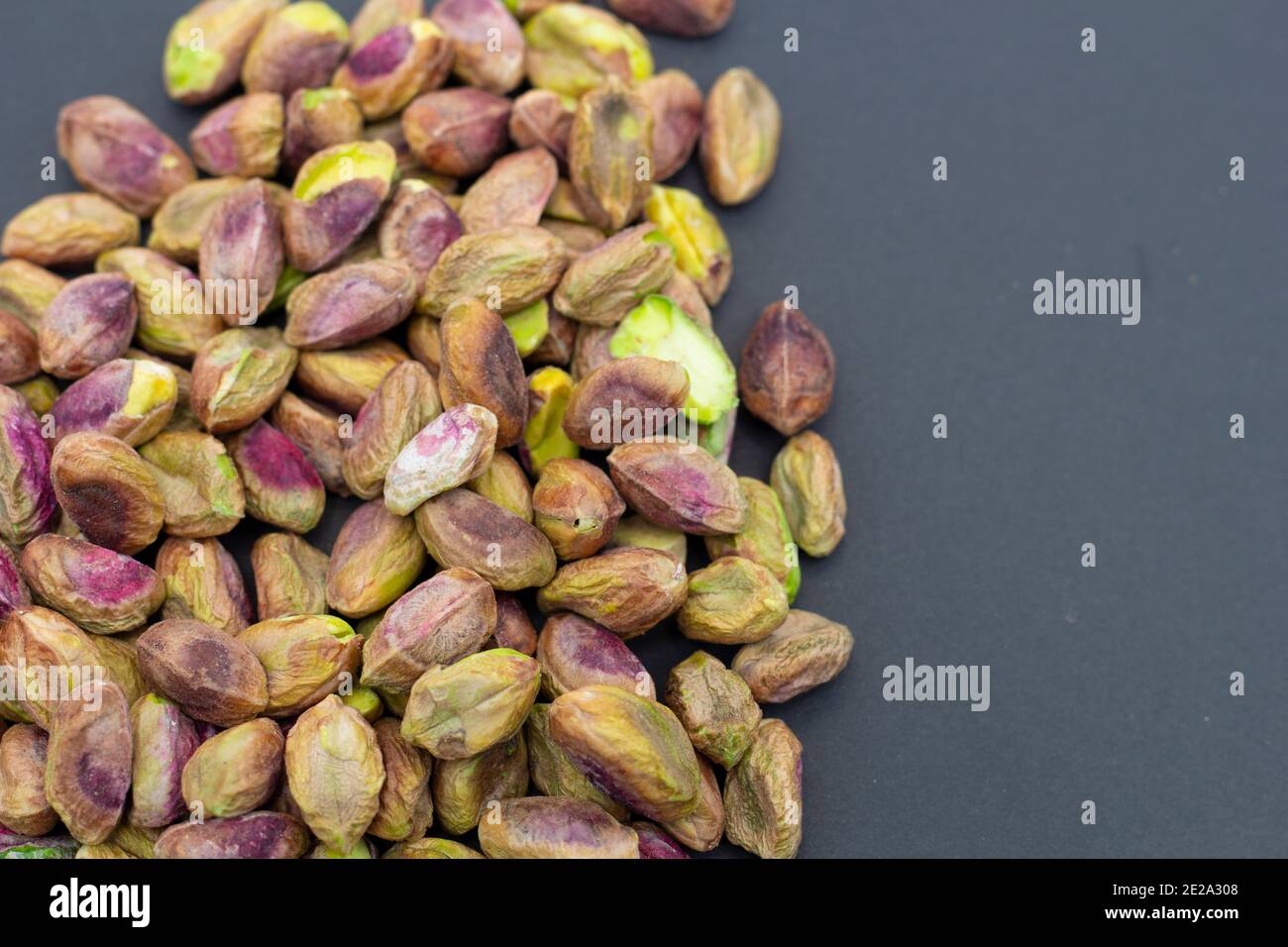 Fresh raw peeled pistachios isolated on Black background Stock Photo ...