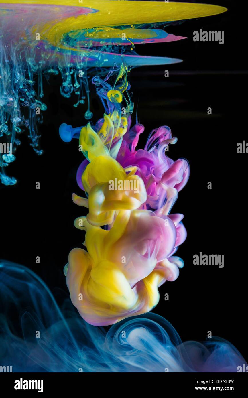 Colored inks in water on black background Stock Photo - Alamy