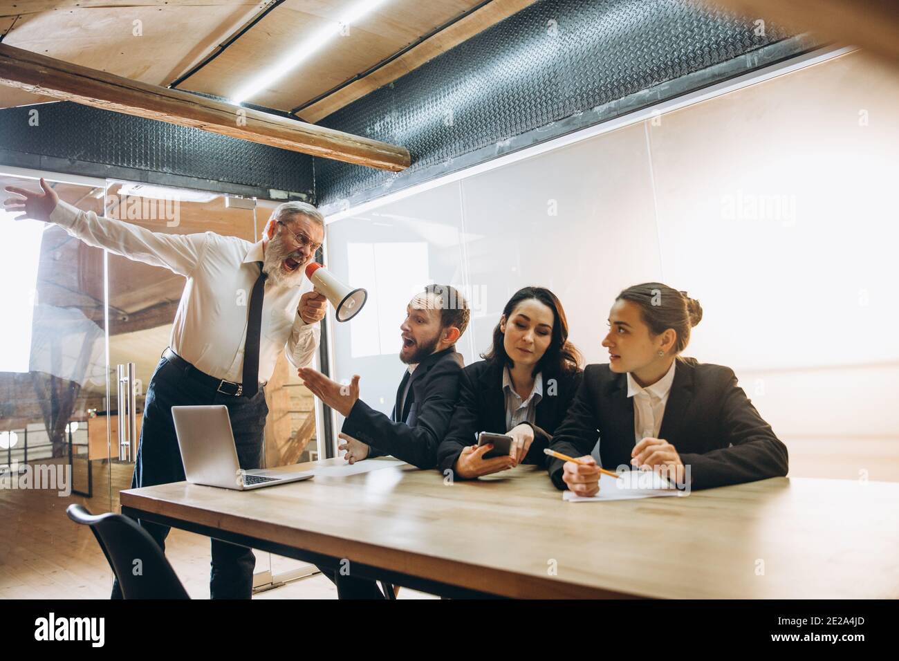 Fired. Angry boss with megaphone screaming at employees in office ...