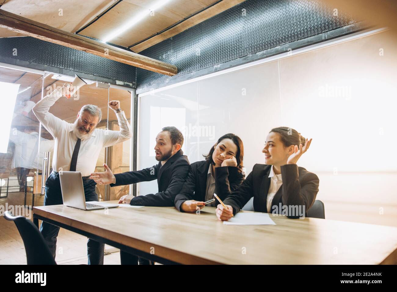Monster. Angry boss with megaphone screaming at employees in office ...