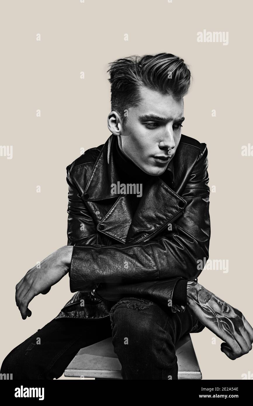 Serious young man posing isolated over light studio background Stock ...