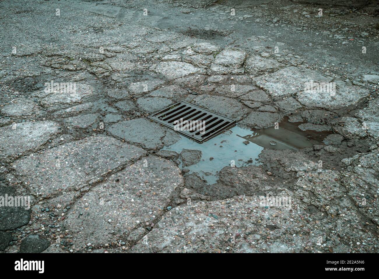 High angle shot of a hole filled with water on the ground Stock Photo ...