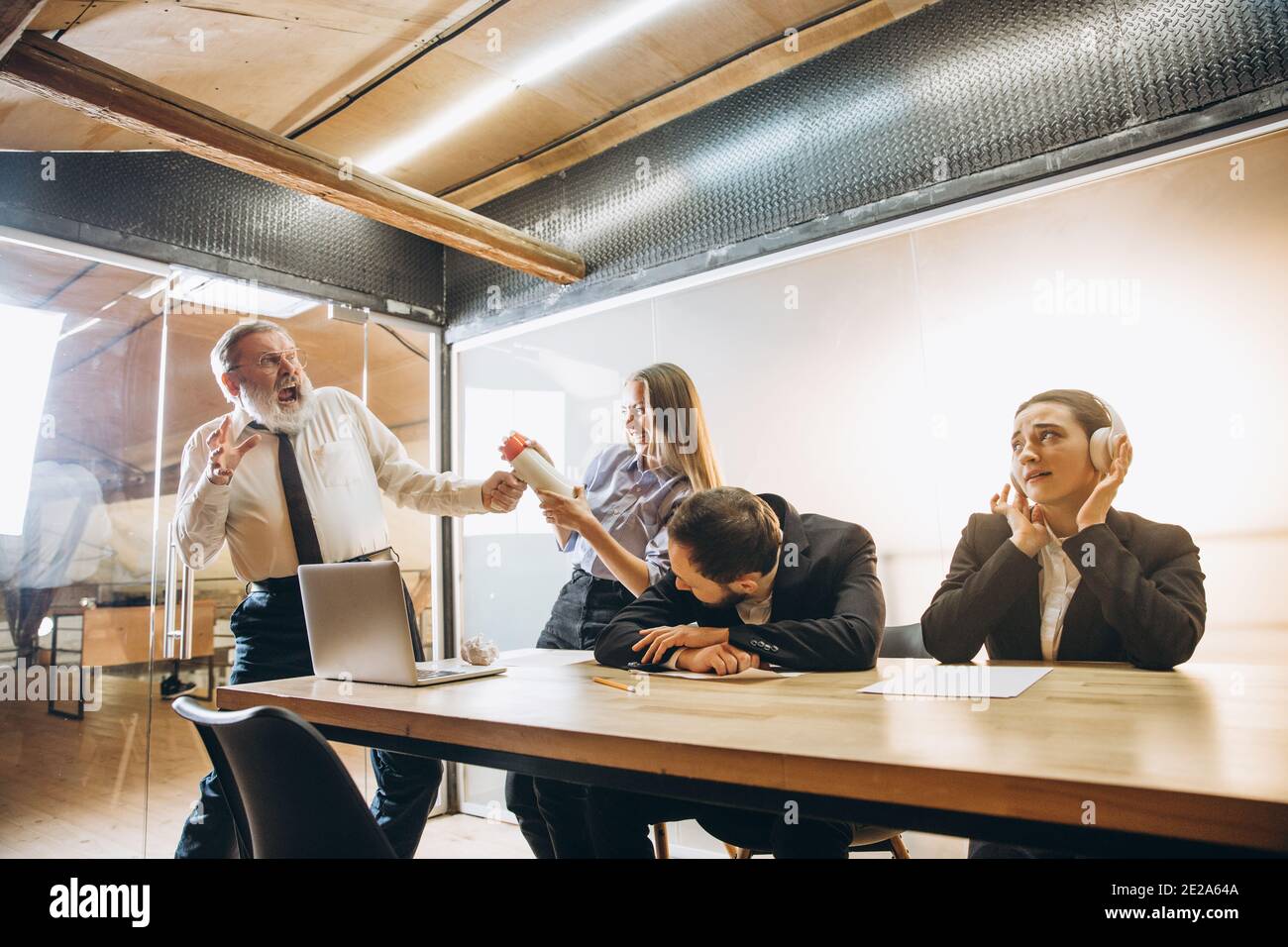 Enought. Angry boss with megaphone screaming at employees in office ...