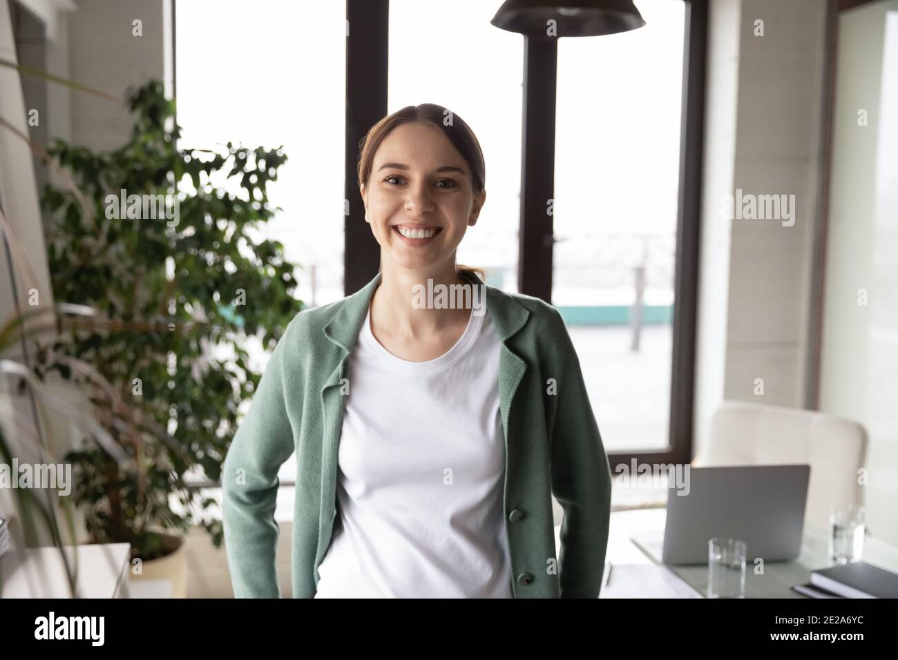Portrait of smiling Caucasian female employee at workplace Stock Photo ...
