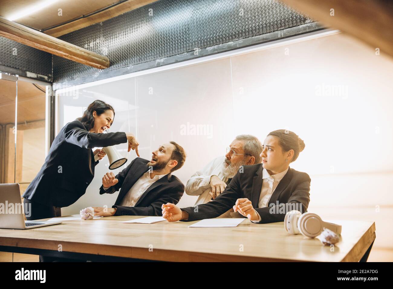 Fighting. Angry boss with megaphone screaming at employees in office ...