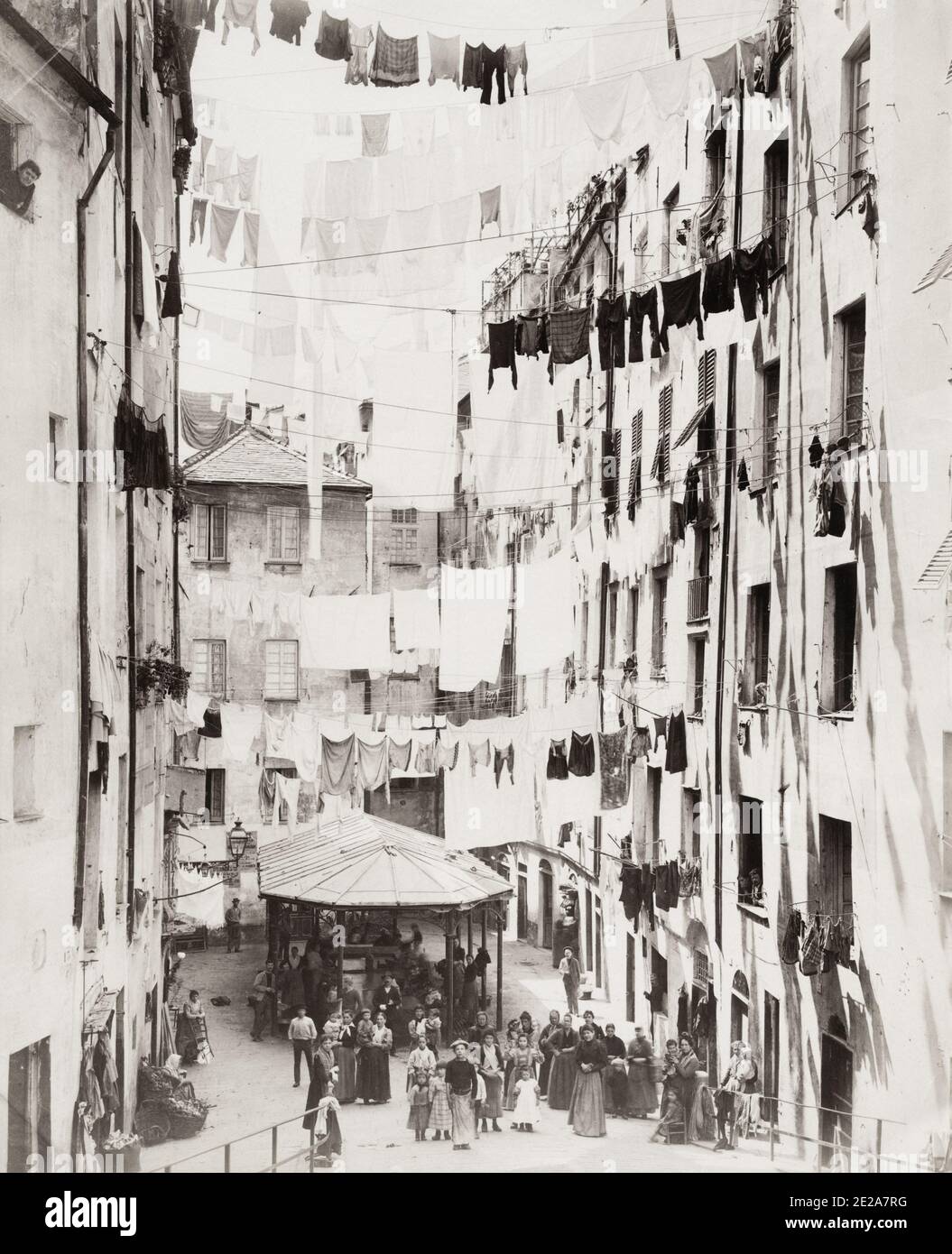 Vintage 19th century photograph: working class street with overhanging ...