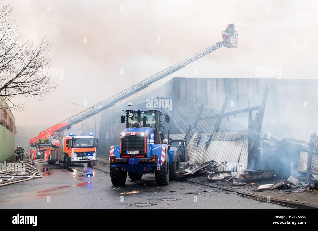 Hamburg, Germany. 13th Jan, 2021. Firefighters extinguish a major fire ...