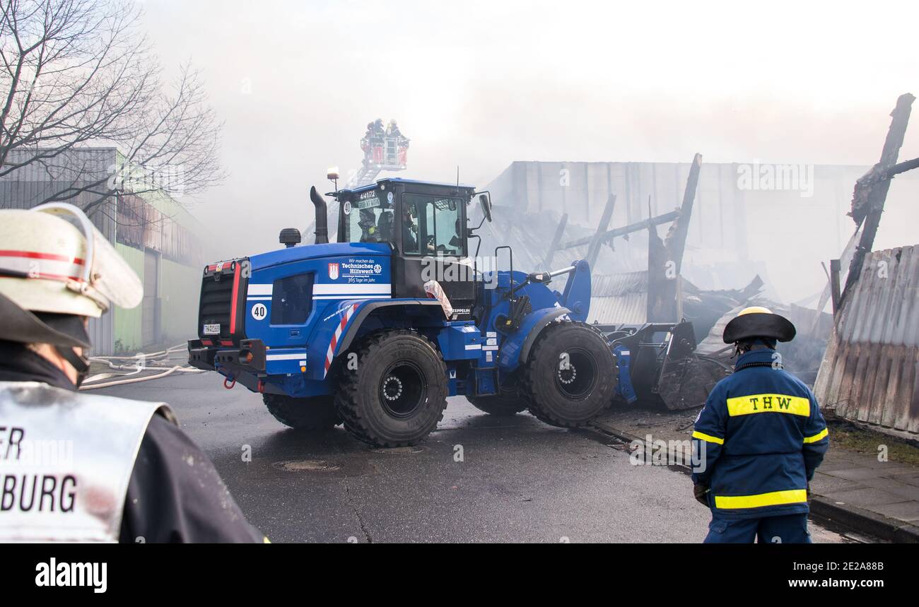 Hamburg, Germany. 13th Jan, 2021. Firefighters extinguish a major fire ...