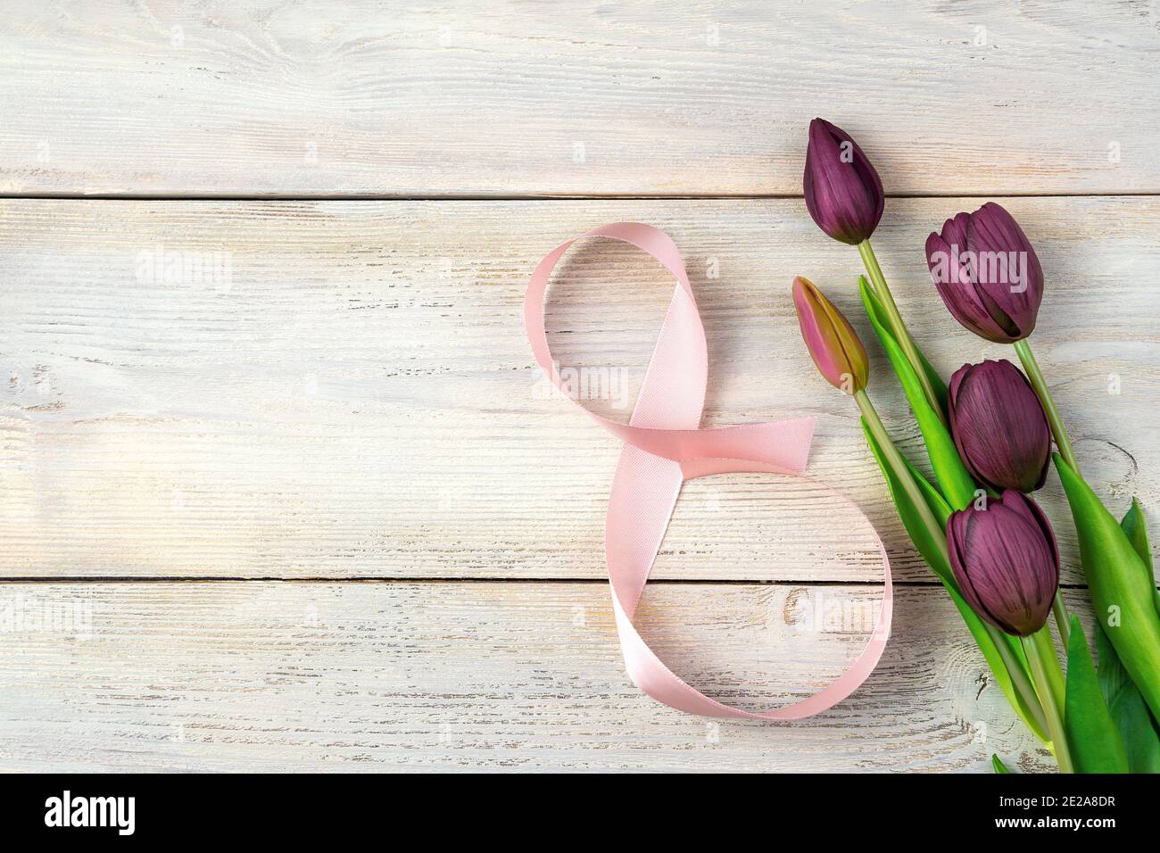 Tulips and the number eight from a ribbon on a light background. Top ...