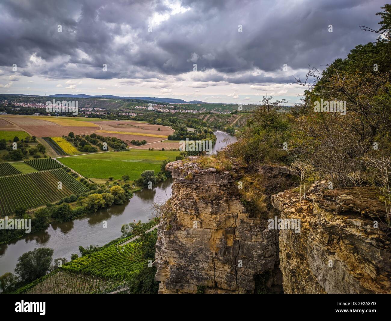 Mesmerizing panorama of an agricultural area surrounded by river rocks ...