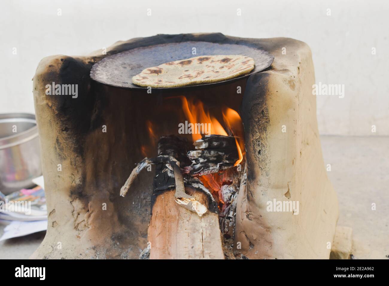 Preparation of chapati in a traditional way on a wood fired oven Stock ...