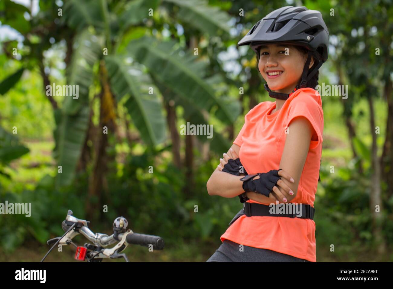 portrait of young asian woman cyclist with bike Stock Photo - Alamy