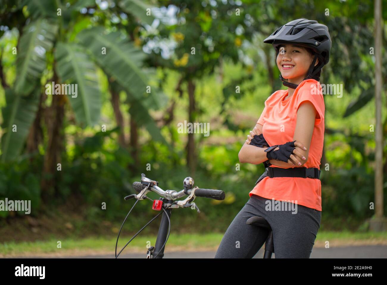 portrait of young asian woman cyclist with bike Stock Photo - Alamy