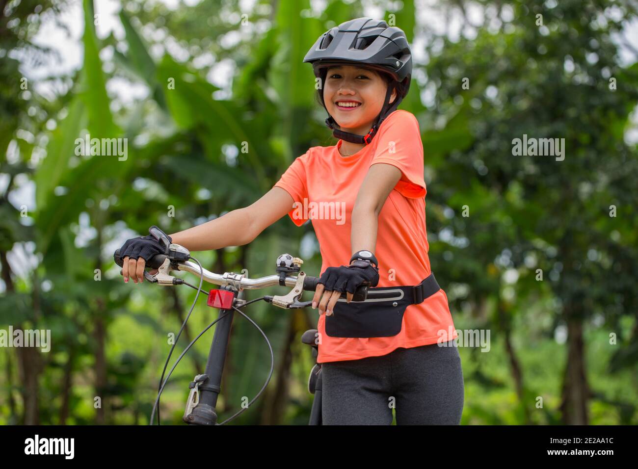 portrait of young asian woman cyclist with bike Stock Photo - Alamy